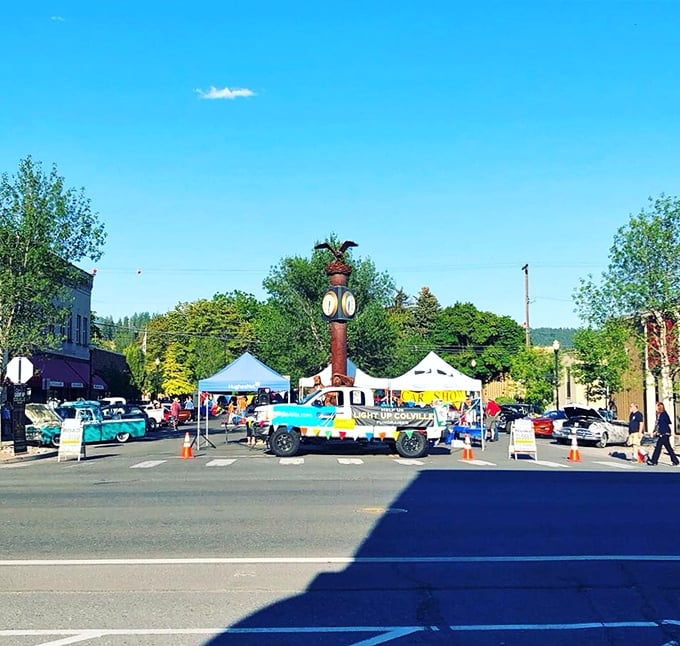 The iconic town clock stands sentinel over Colville's vibrant farmers market, where locals gather to shop, socialize, and soak up sunshine under impossibly blue Washington skies.