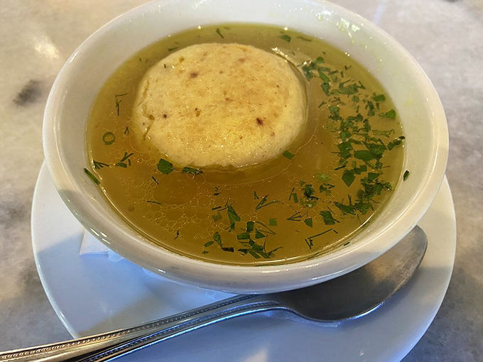 The matzo ball soup&mdash;golden broth cradling a perfect dumpling&mdash;is Jewish penicillin that could cure anything from sniffles to existential dread.