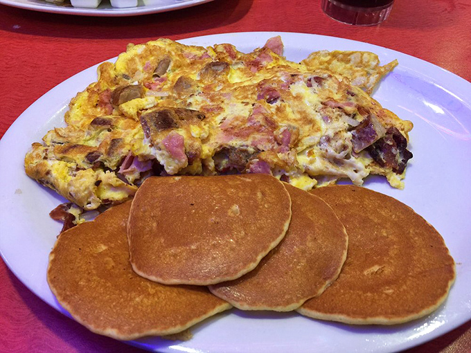 This omelet contains more fillings than most people's refrigerators, paired with pancakes that achieve that elusive golden-brown perfection.