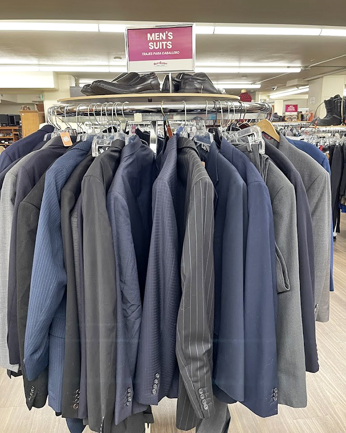 Men's suits hang with dignity, waiting for their next interview, wedding, or perhaps an impromptu James Bond impersonation.
