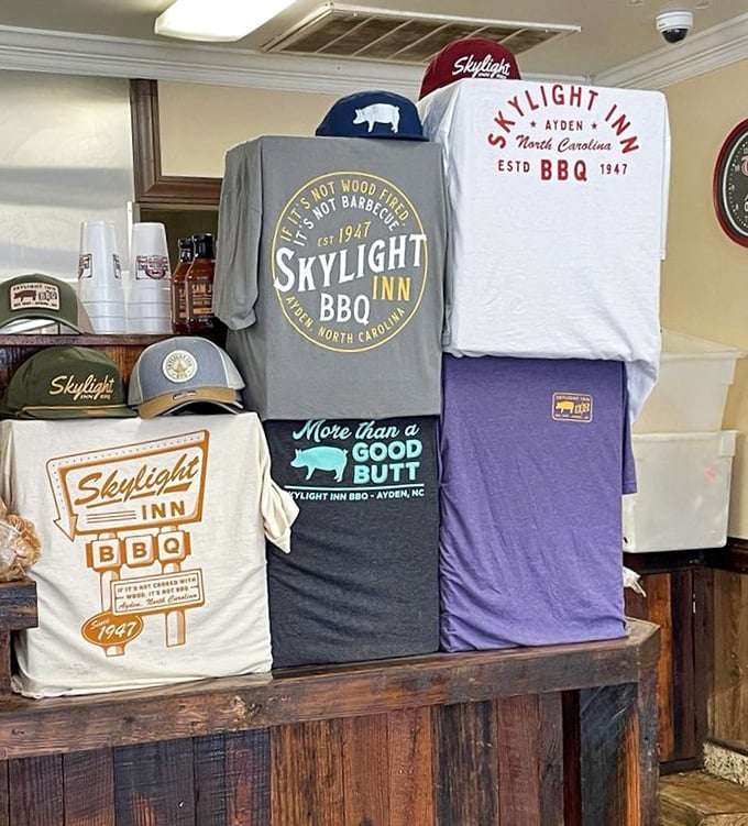 "If it's not wood fired, it's not BBQ"—the t-shirt says it all. Skylight Inn doesn't just serve barbecue; it preaches the gospel of smoke and pork.