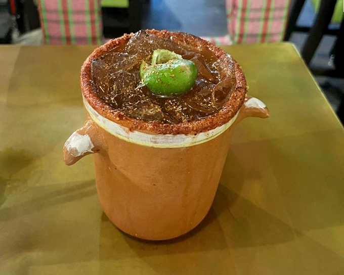 The michelada arrives like a spicy, savory cocktail in clay clothing&mdash;that salt-rimmed edge and lime garnish promising the perfect companion to anything on the menu.