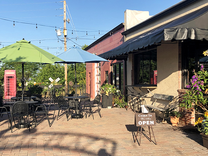 Colorful umbrellas and inviting outdoor seating create the perfect spot for people-watching with your morning coffee.