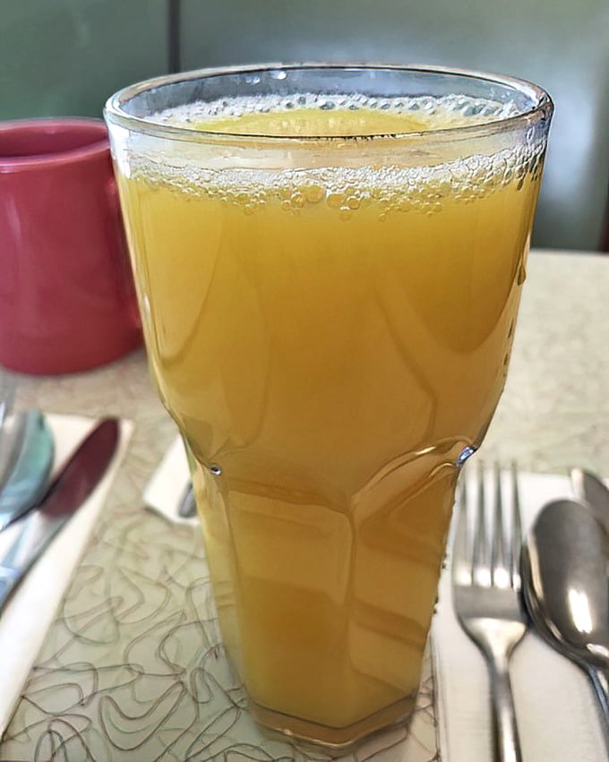 Orange juice in a classic diner glass&mdash;nature's perfect palate cleanser between bites of buttery biscuit and salty country ham.