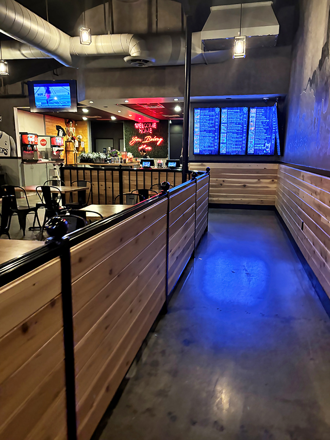 The path to barbecue nirvana is lined with wood paneling and illuminated by a menu board that reads like a love letter to meat.
