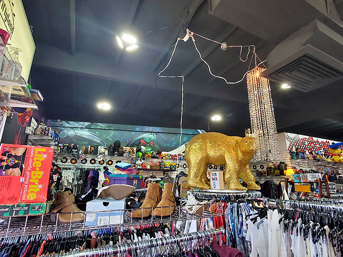 The golden bear watches over all. This surreal shopping landscape, complete with chandelier and boots, epitomizes Thriftyland101's delightful retail chaos.