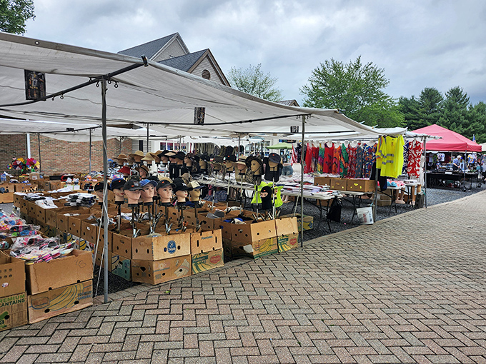 Under white canopies, vendors arrange their wares in hopeful displays, creating a marketplace rhythm that hasn't changed for centuries.