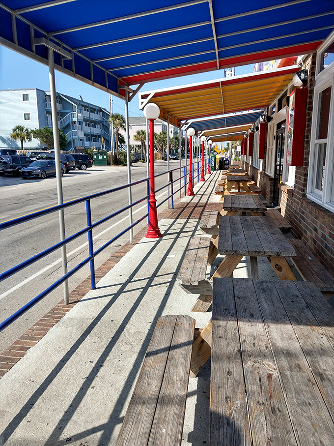 Outdoor seating where sea breezes enhance every bite. These weathered wooden benches have stories to tell&mdash;if only they could talk between meals.