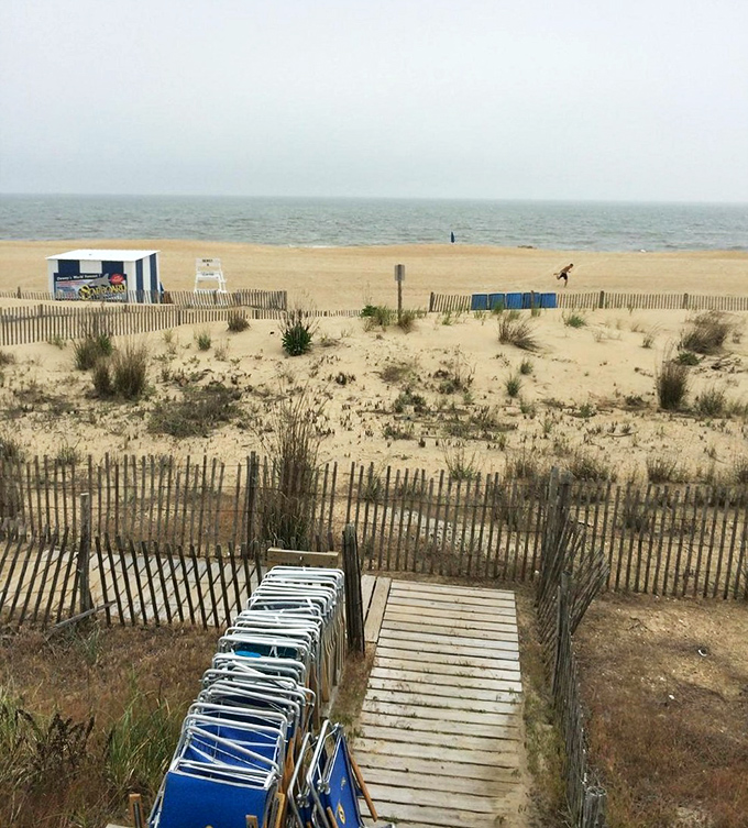Beach access paths and dune grasses create a quintessential coastal tableau that whispers "vacation has begun."
