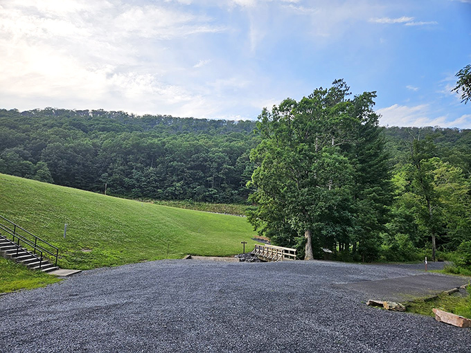 Rolling hills embrace a perfect patch of green, creating an amphitheater where the only performance is the daily dance of light and shadow.
