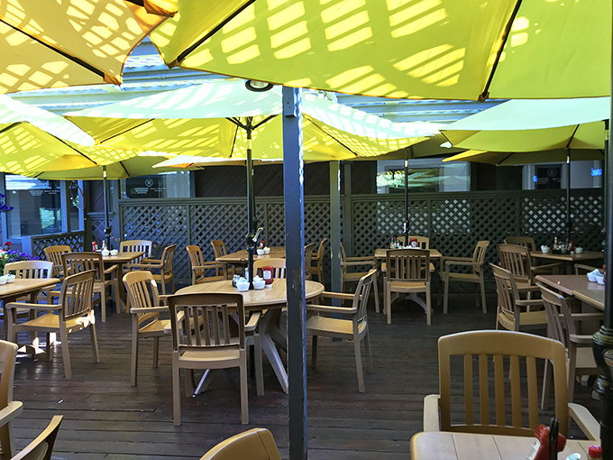 Under yellow umbrellas, every table becomes the best seat in the house. Mountain air makes everything taste better.