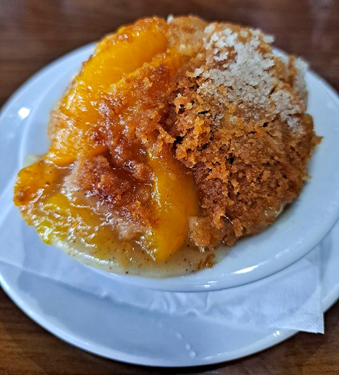 Peach cobbler glistening under its sugary crust &ndash; Georgia's state fruit getting the royal treatment it deserves.