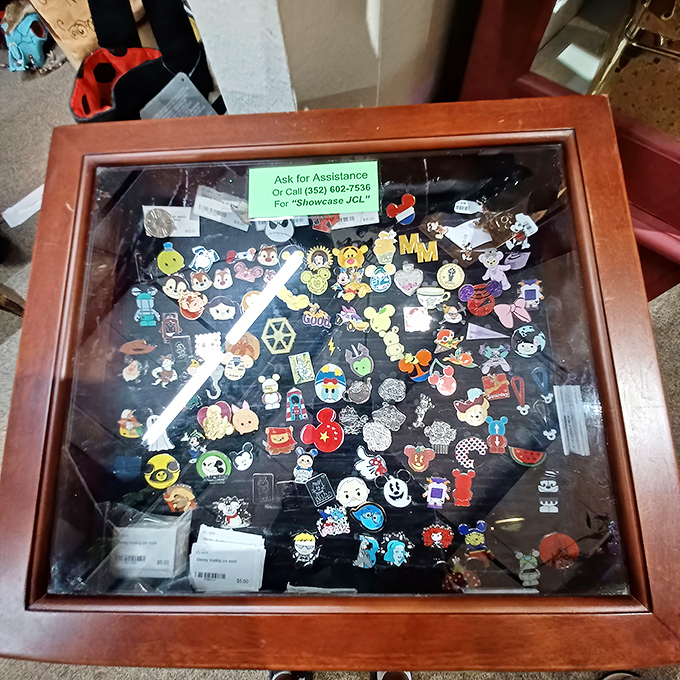 Disney characters mingle with pop culture icons in this pin collector's dream case. Each tiny emblem represents someone's fandom, vacation memory, or childhood obsession.