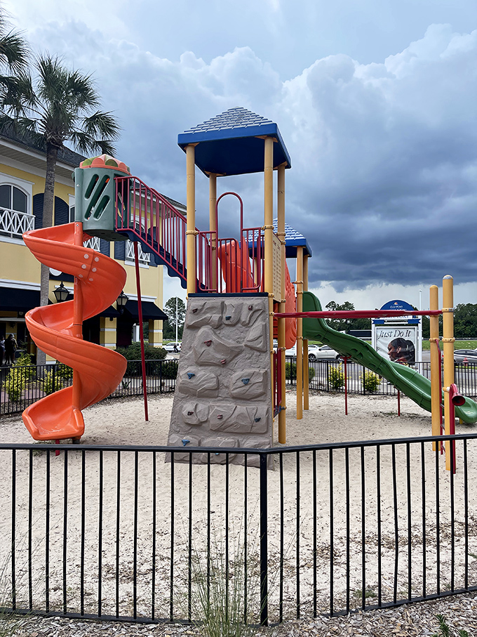 Kid-friendly playground where little ones burn energy while parents contemplate burning through their shopping budget.