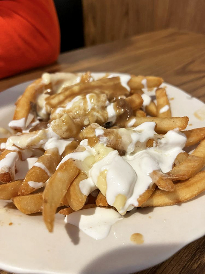 Poutine that doesn't need a passport &ndash; crispy fries swimming in gravy and cheese curds that would make a Canadian nod in approval.