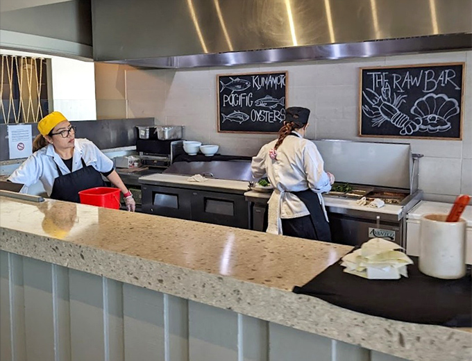 Behind the scenes, culinary artists prepare the day's catch with the precision of surgeons and the creativity of jazz musicians.