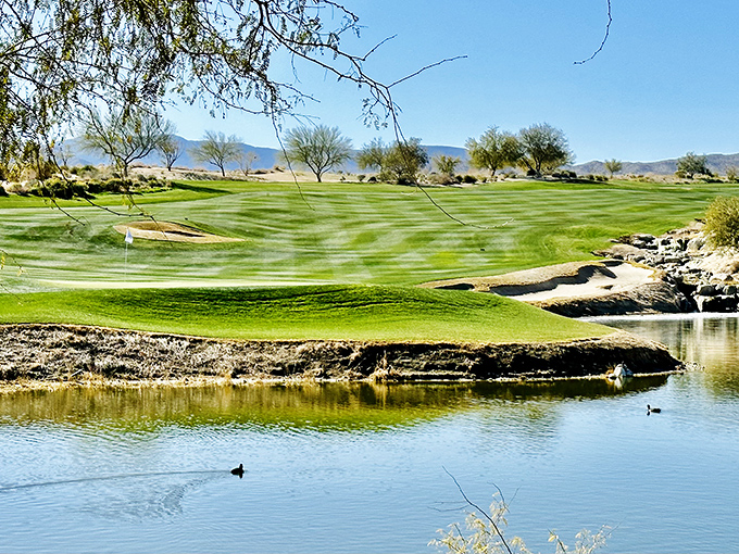 Ram's Hill Golf Club creates an emerald mirage against the desert palette, where water hazards seem like impossible luxury in this arid landscape.