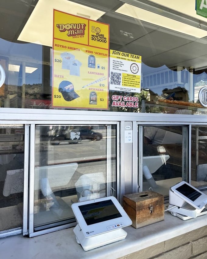 The storefront window offers a glimpse into donut paradise, where merchandise proves they've achieved the ultimate California dream: becoming a lifestyle brand.