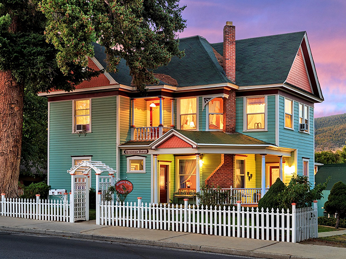 This charming Victorian B&B glows with twilight warmth, promising the kind of peaceful night's sleep that big-city hotels charge triple for but can never deliver.