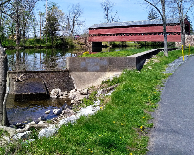 The Sachs Covered Bridge spans peaceful waters near Gettysburg, its distinctive red boards sheltering travelers just as they did during the Civil War.