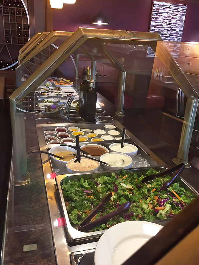 The salad bar stands like a fresh oasis, offering crisp greens and colorful dressings to complement your main artichoke adventure.