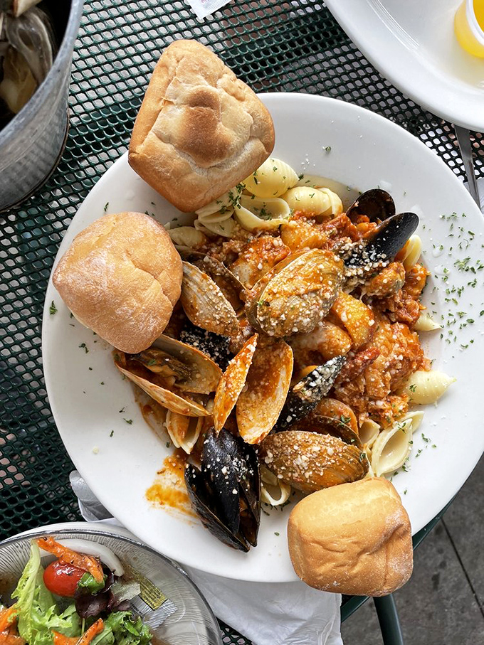This isn't just seafood pasta&mdash;it's an underwater symphony where clams, mussels, and crusty bread perform a delicious harmony in tomato sauce.