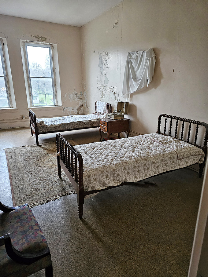 Two beds, one room, countless stories. The simple accommodations speak volumes about the lives once lived within these institutional walls.