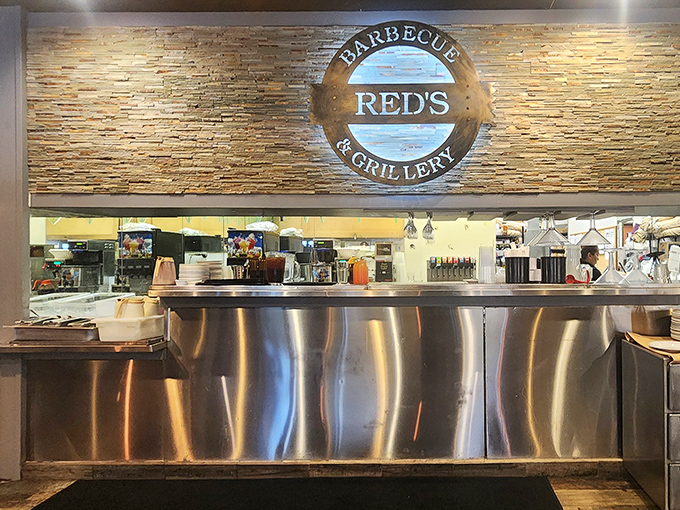 The service counter where barbecue dreams come true, backed by a stone wall that's witnessed countless "first bite" expressions of pure joy.