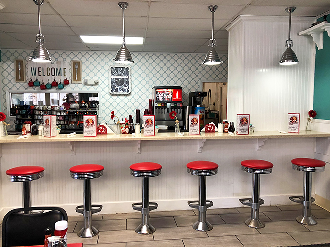 Classic counter seating with fire-engine red stools – where solo diners become temporary members of the breakfast club.