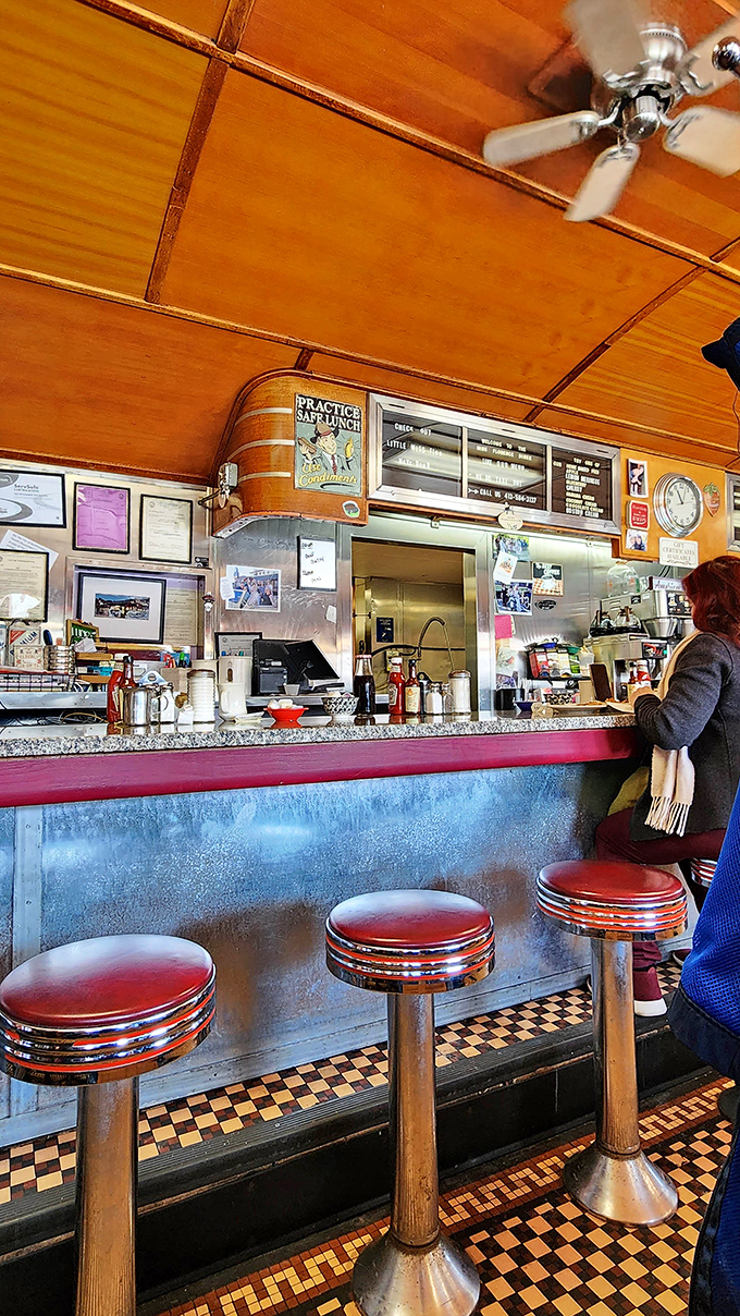 Warm wood paneling and that curved ceiling create the classic diner car ambiance that no modern restaurant designer could ever truly replicate.