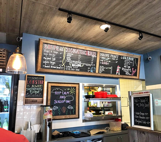 Maritime meets modern with weathered wood, pendant lighting, and ocean-blue walls. Even the TV seems to be showing underwater scenes in solidarity.