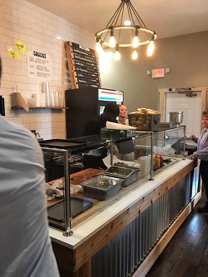 Modern industrial lighting illuminates the temple of smoke, where beverages await to help you navigate the delicious meat sweats ahead.
