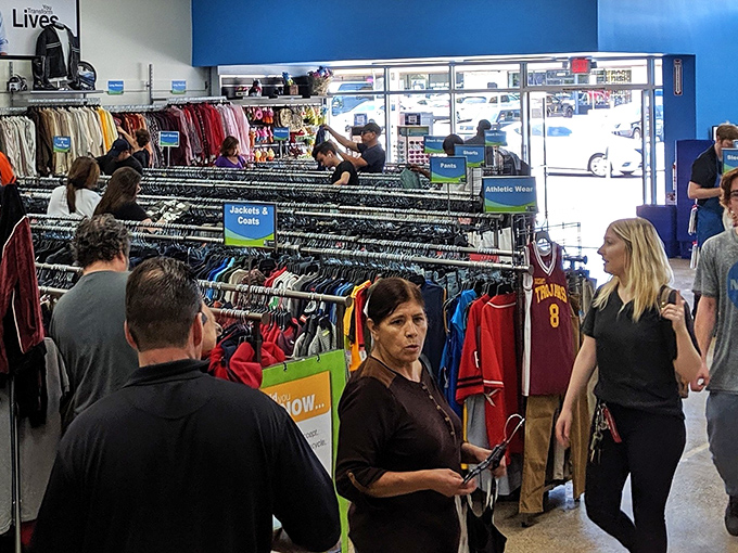 Treasure hunters in their natural habitat&mdash;notice the focused expressions as they scan for that elusive perfect find among the racks.