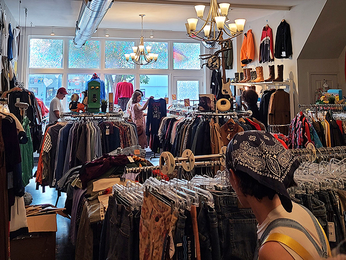 The store's bright, airy interior makes vintage shopping feel like a treasure hunt in someone's exceptionally well-organized attic, complete with chandeliers.