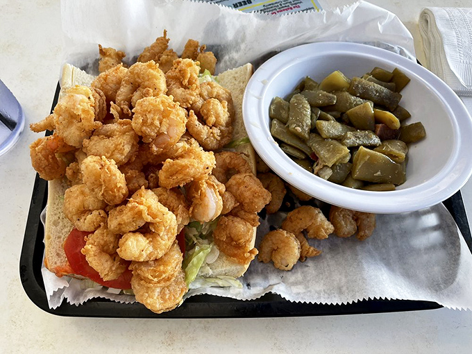 That po-boy overflows with fried shrimp like someone forgot to stop adding toppings, which is exactly the kind of mistake we celebrate.