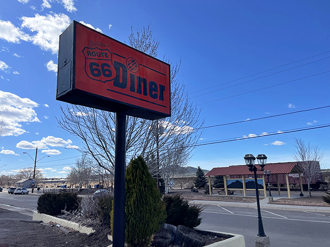 The sign stands tall against the Arizona sky, a red-and-black promise of comfort food that's been fulfilling hungry travelers' dreams for generations.