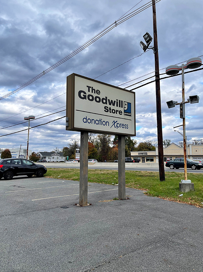 The roadside sign stands as a beacon to bargain hunters traveling along Route 23, signaling both shopping opportunities and donation possibilities.