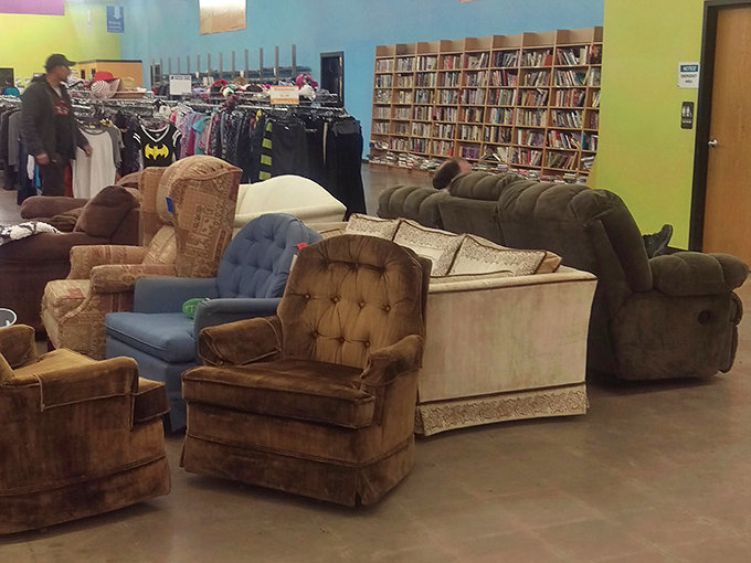 The sofa section: a velvet and microfiber reunion where every chair looks like it has a story to tell. That brown recliner has definitely seen some Super Bowls.
