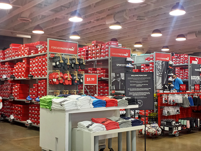 The wall of red shoeboxes promises athletic performance improvements or, at minimum, looking sporty while getting coffee.