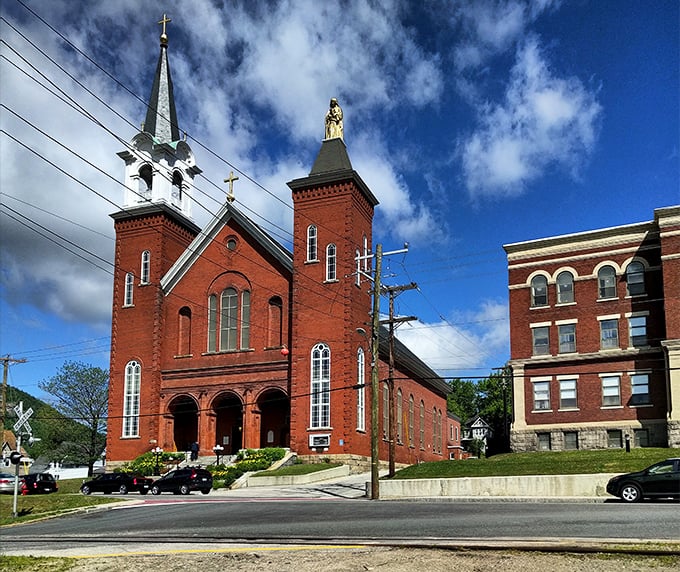 St. Anne Catholic Church's twin towers stand sentinel over Berlin, brick-red guardians of faith and community through changing seasons.