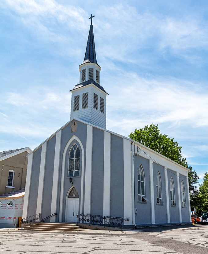 St. John Catholic Church's pristine white steeple reaches skyward. Faith and community intertwine in Wapakoneta as naturally as the Ohio rivers.