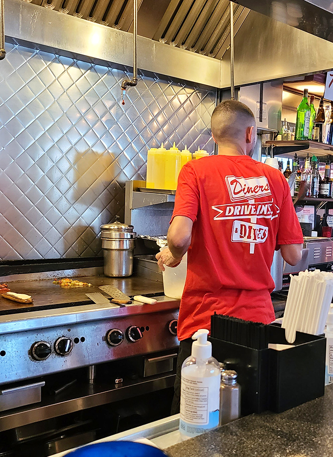 The kitchen crew works their morning magic, wearing their passion for diner culture proudly on their backs.