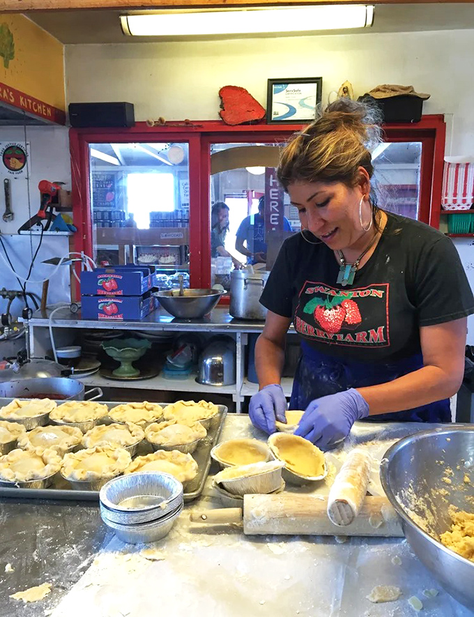 Pie artistry in progress! Skilled hands transform simple ingredients into the kind of dessert that creates lifelong memories and family traditions.