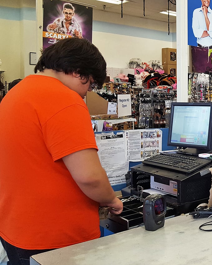 A cashier rings up someone's newfound treasures, the final step in the item's journey from donation to destination.