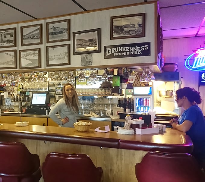 The bar area combines vintage photos with neon signs, creating that perfect "been here forever" vibe that no corporate restaurant can replicate.