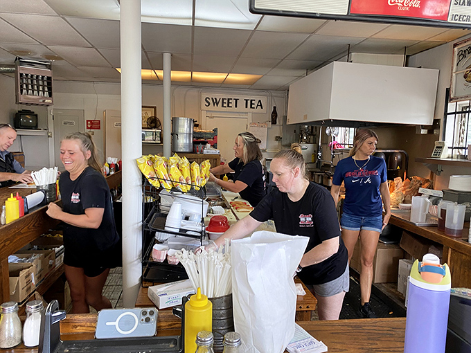 The staff moves with the choreographed efficiency that comes only from years of perfecting the art of hot dog assembly.