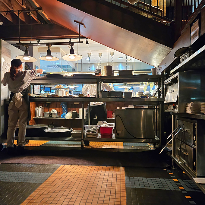 Skilled kitchen staff working their magic, transforming fresh Gulf seafood into culinary masterpieces with practiced precision.