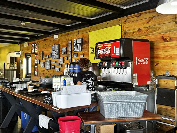 Behind the counter, where the magic happens&mdash;wooden walls, cheerful staff, and a sign that reminds you to "Eat More Bacon." Solid advice.