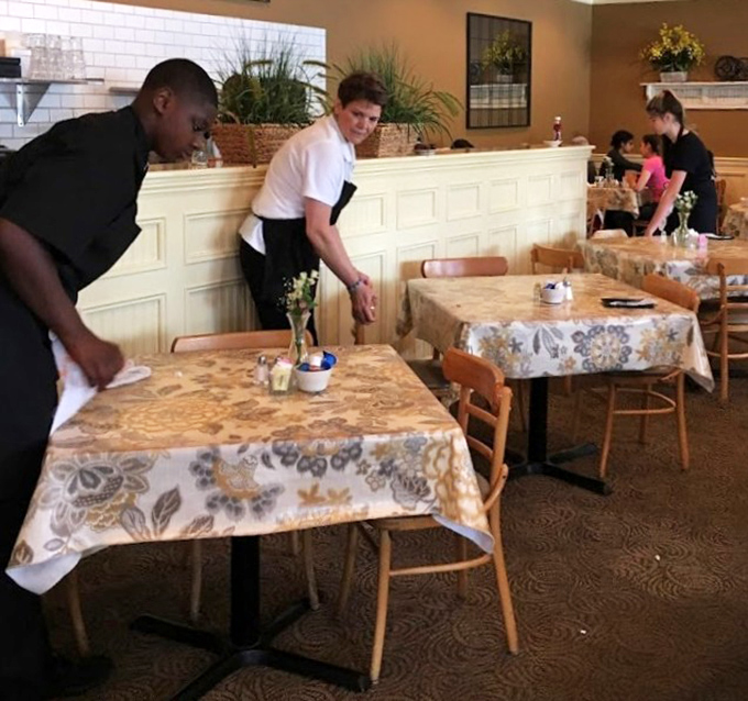 The breakfast ballet in action &ndash; servers gliding between tables with practiced precision. Those tablecloths have witnessed countless morning revelations.