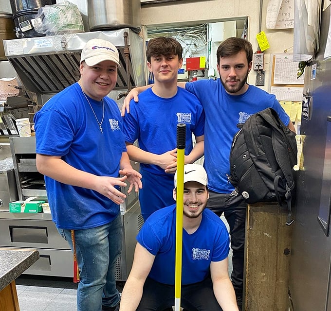 The crew behind the magic—these blue-shirted seafood wizards transform simple ingredients into the dishes that keep locals coming back and visitors spreading the word.